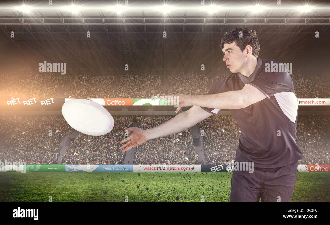 Composite image of rugby player doing a side pass Stock Photo - Alamy