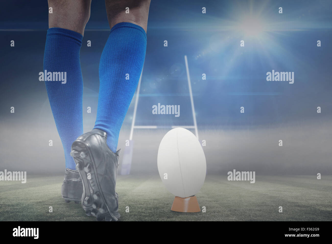 Composite image of low section of rugby player about to kick the ball ...
