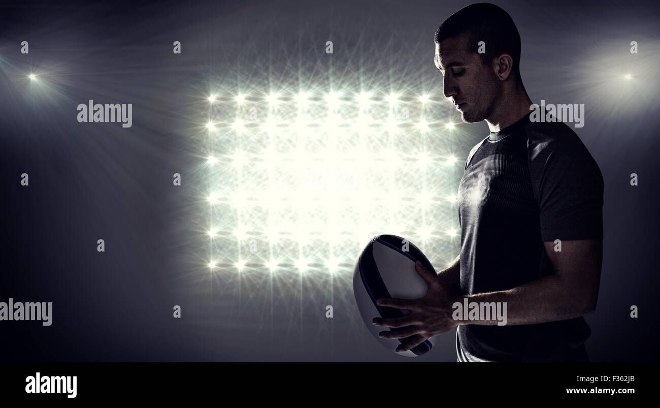 Composite image of calm rugby player thinking while holding ball Stock ...