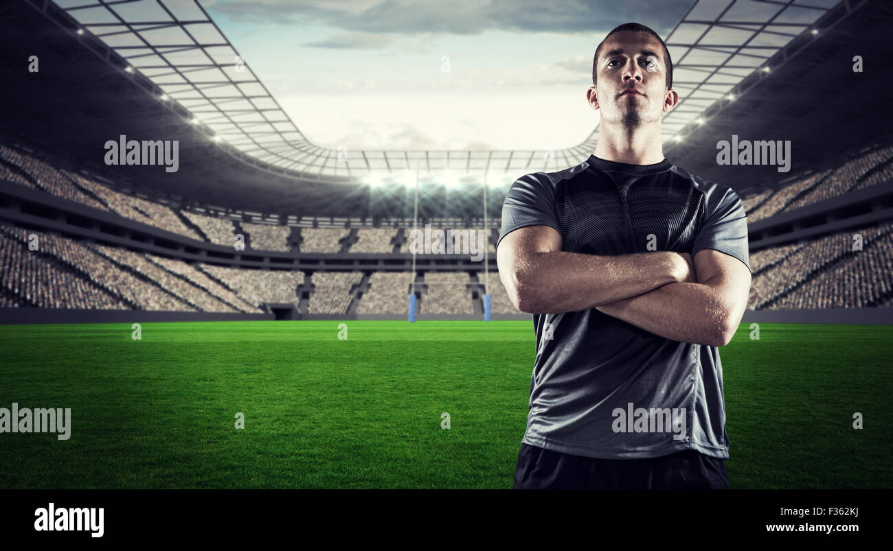 Composite image of confident rugby player with arms crossed Stock Photo ...