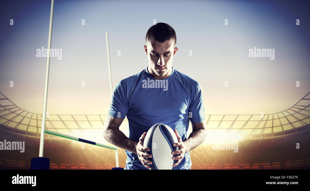 Composite image of rugby player holding ball Stock Photo - Alamy