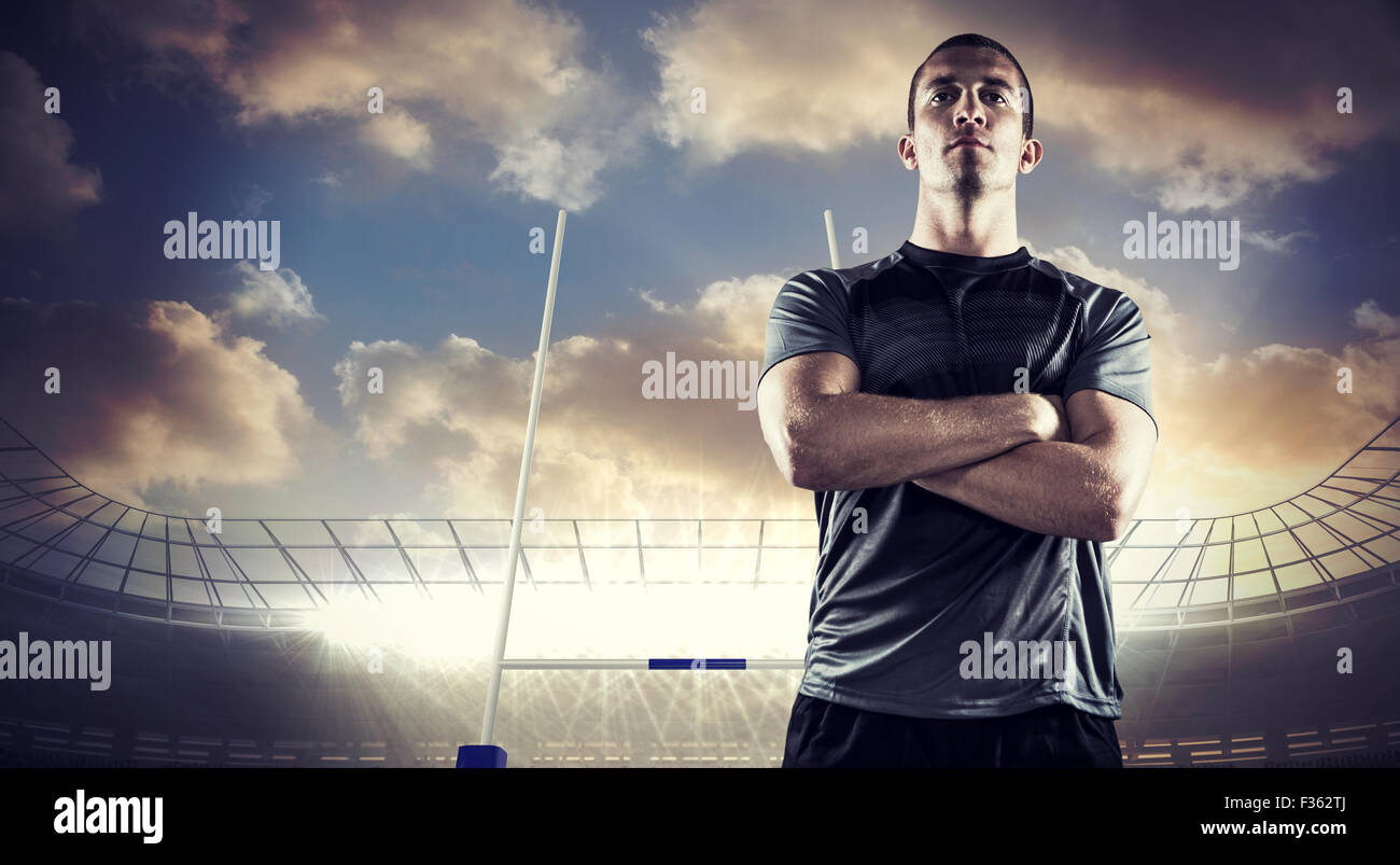 Composite image of confident rugby player with arms crossed Stock Photo ...