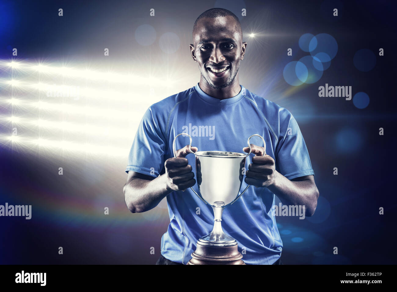 Composite image of portrait of happy athlete holding trophy Stock Photo ...