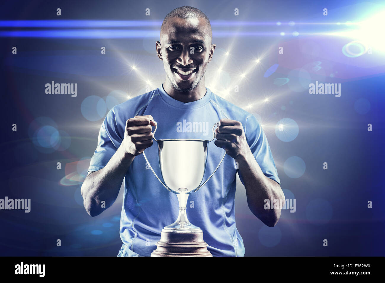 Composite image of portrait of happy sportsman holding trophy Stock ...