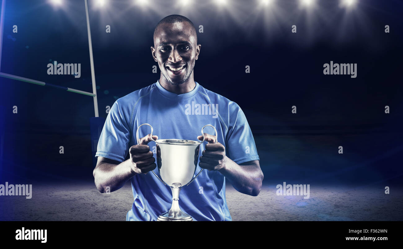 Composite image of portrait of happy athlete holding trophy Stock Photo ...