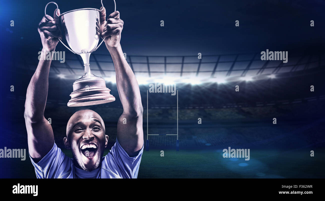 Composite image of happy athlete cheering while holding trophy Stock ...