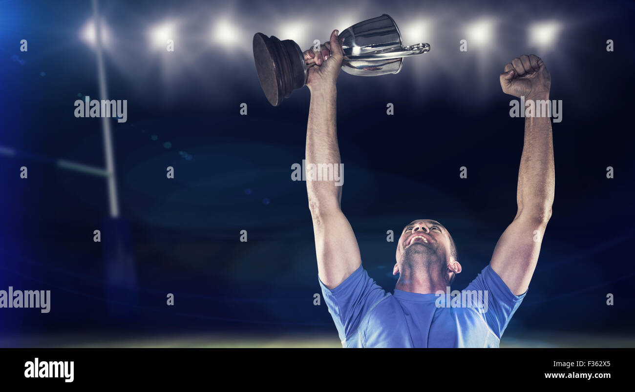 Composite image of happy rugby player holding trophy Stock Photo - Alamy