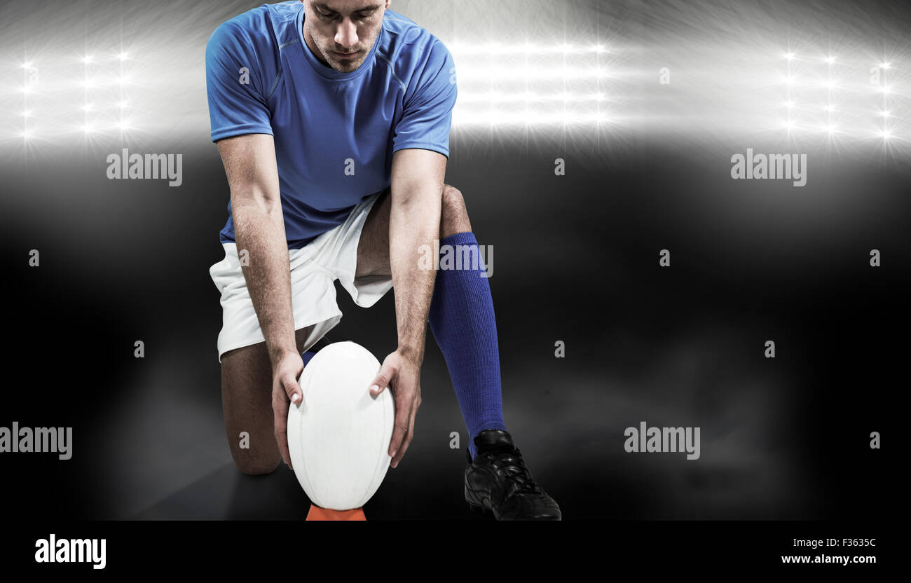 Composite image of full length of rugby player placing ball Stock Photo ...