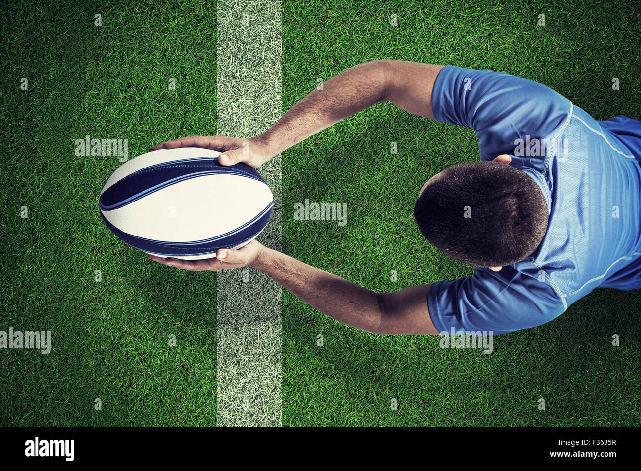 Composite image of rugby player lying in front with ball Stock Photo ...