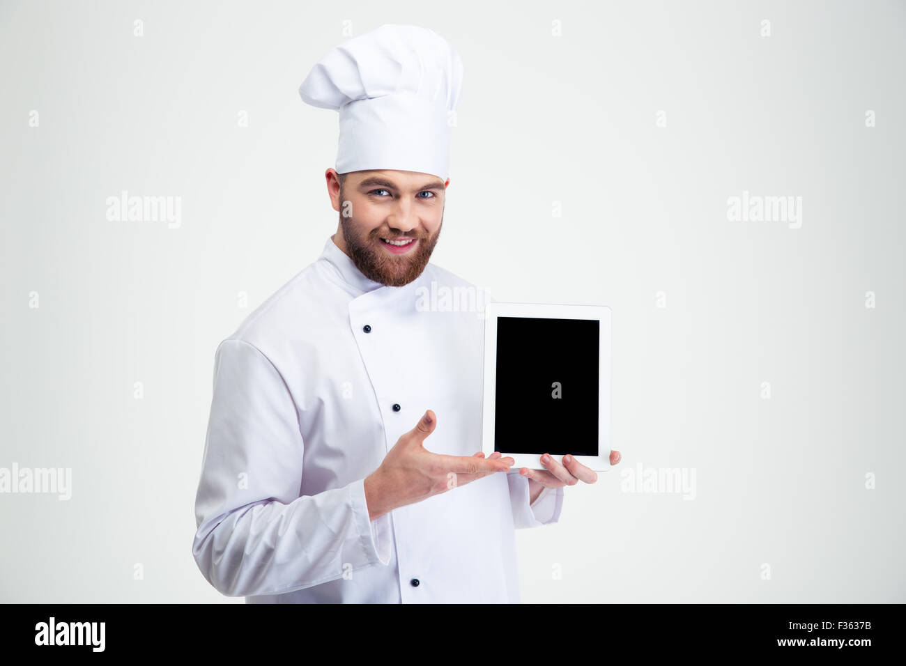 Portrait of a happy male chef cook showing blank tablet computer screen ...
