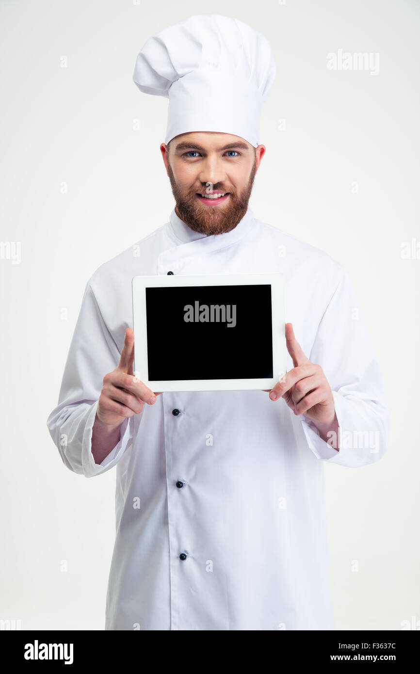 Portrait of a smiling male chef cook showing blank tablet computer ...