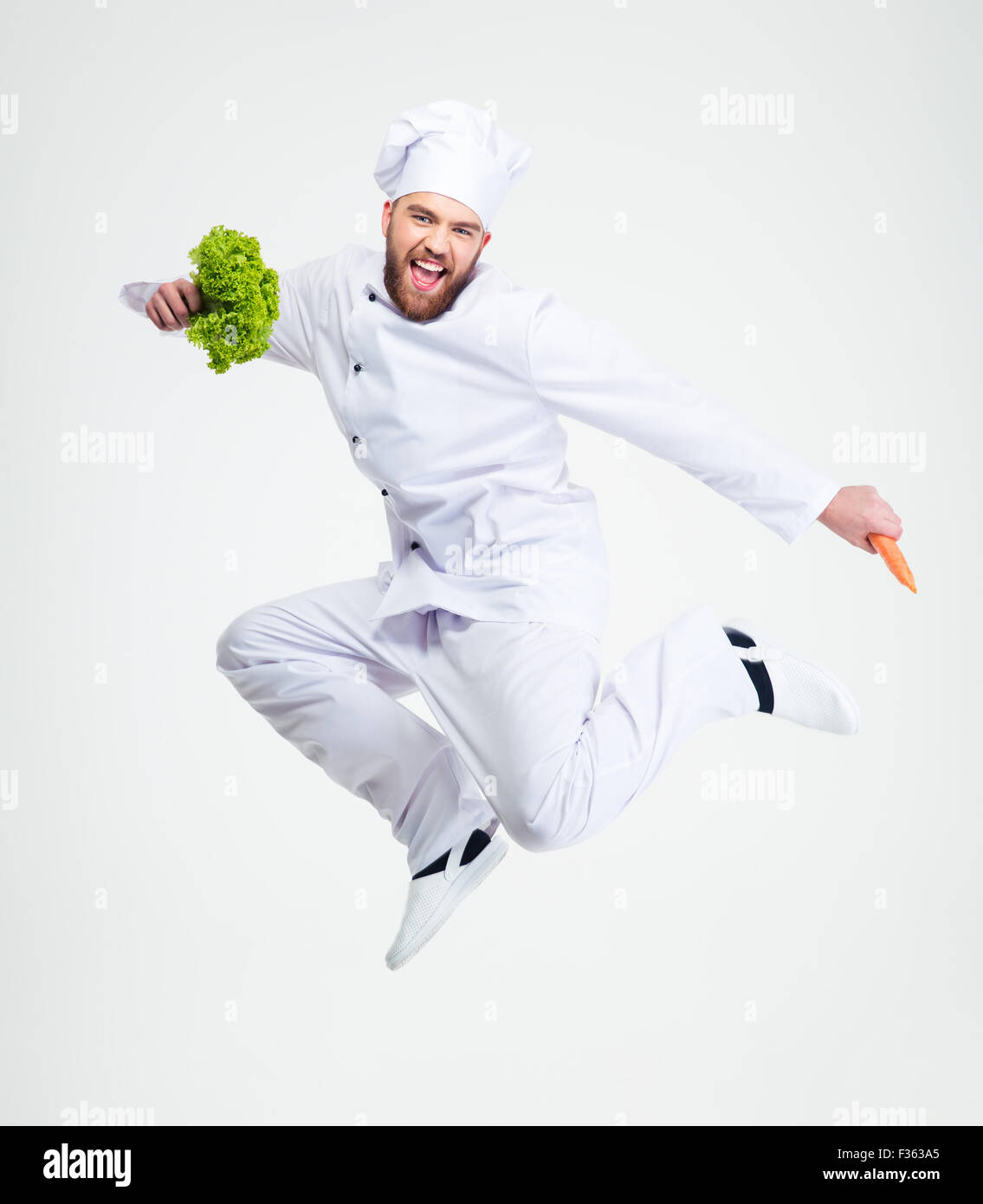 Full length portrait of a cheerful chef cook dancing isolated on a ...