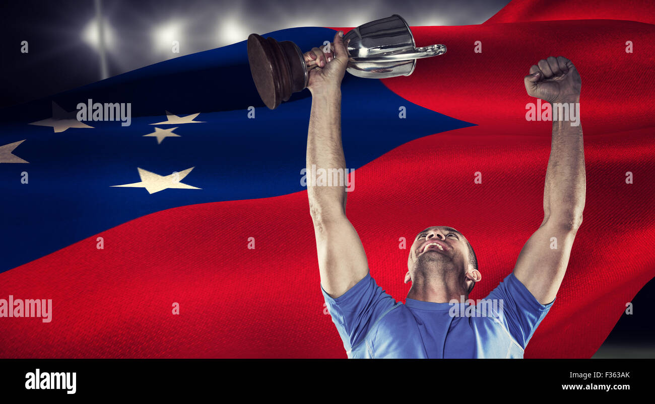 Composite image of happy rugby player holding trophy Stock Photo - Alamy