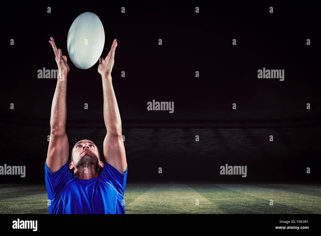 Composite image of rugby player catching ball Stock Photo - Alamy