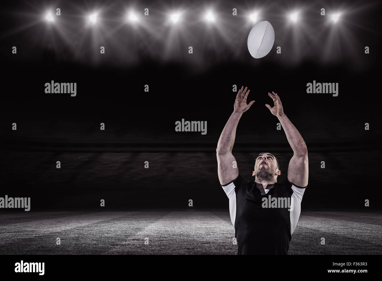 Composite image of rugby player catching the ball Stock Photo - Alamy