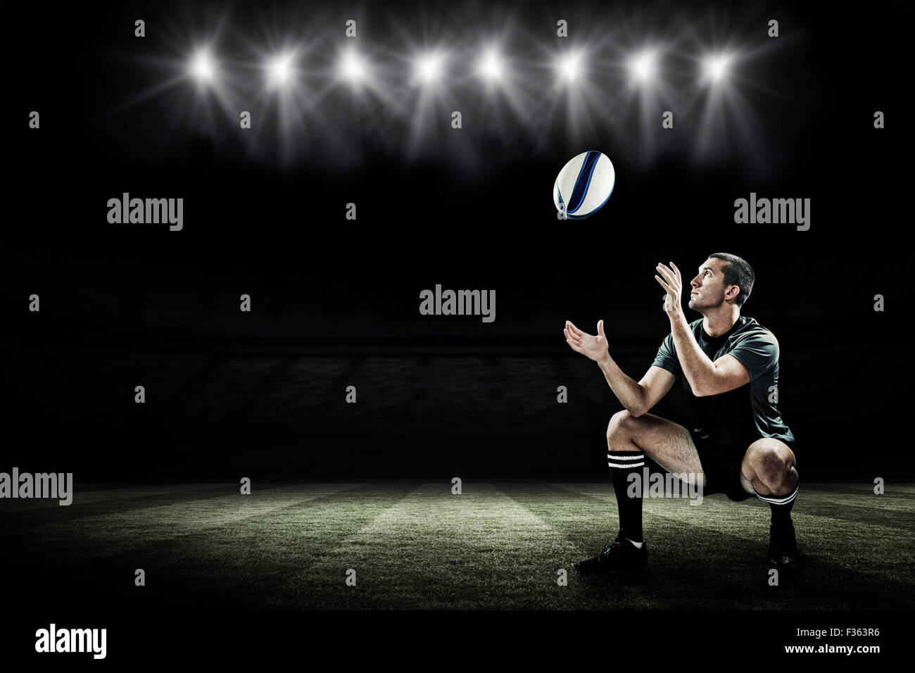 Composite image of full length of rugby player catching the ball Stock ...
