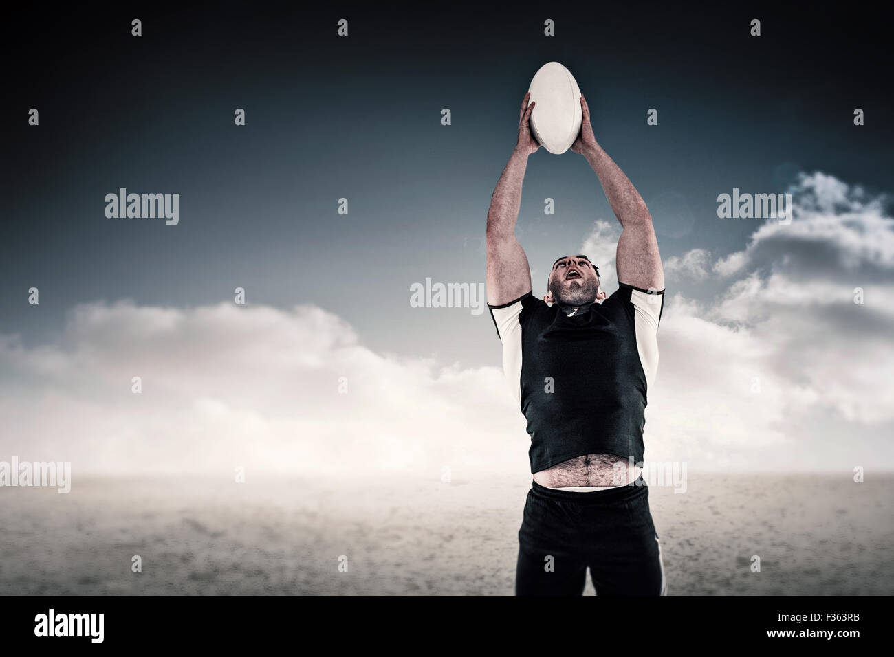 Composite image of rugby player catching the ball Stock Photo - Alamy