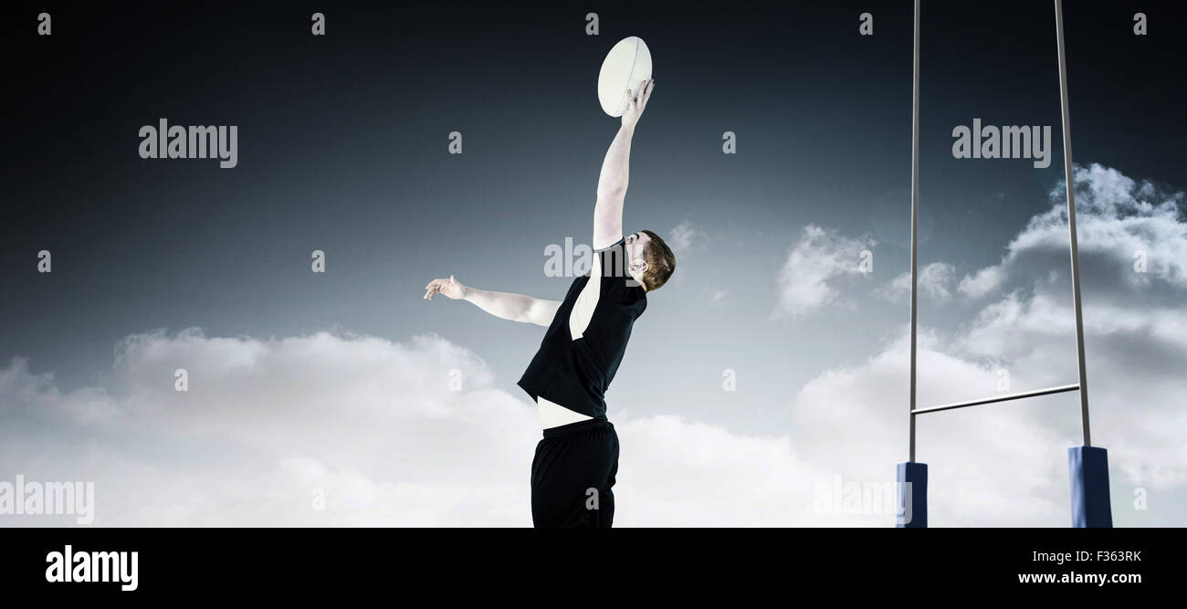 Composite image of rugby player catching a rugby ball Stock Photo - Alamy