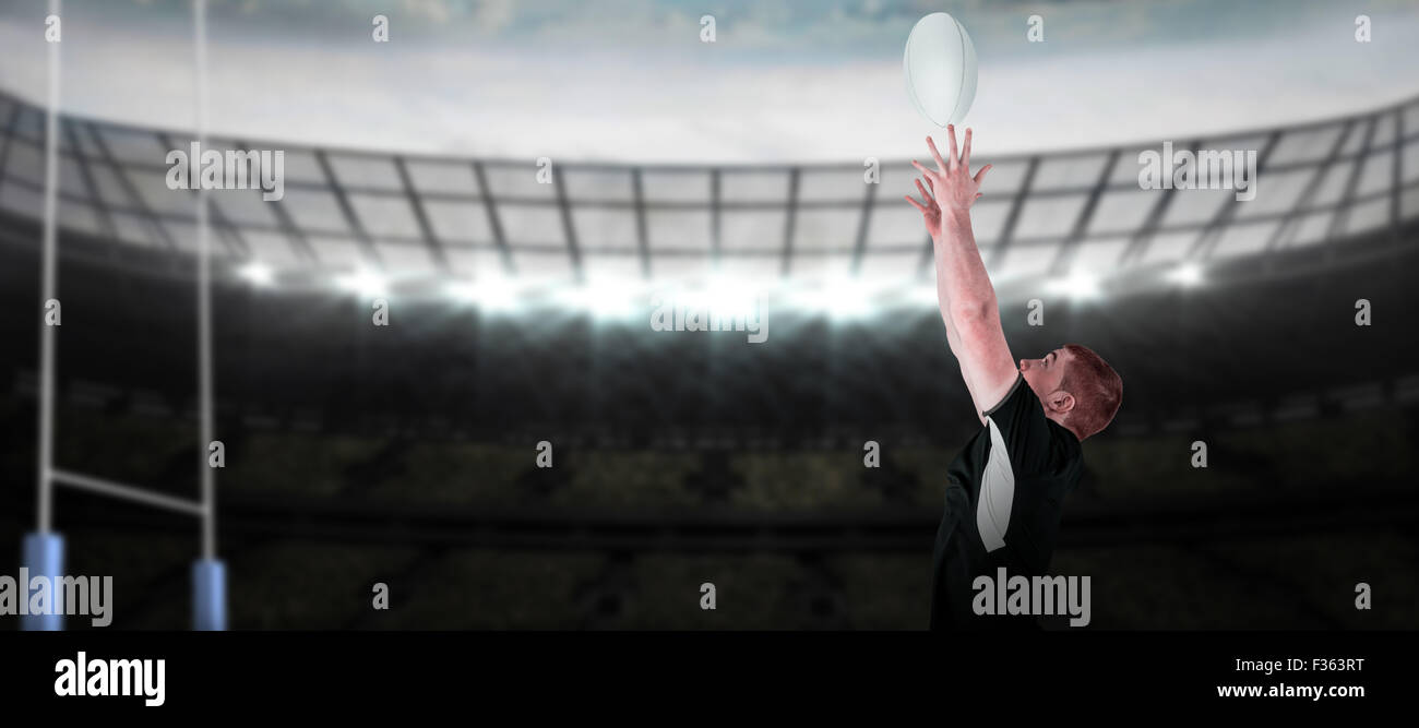 Composite image of rugby player catching a rugby ball Stock Photo - Alamy