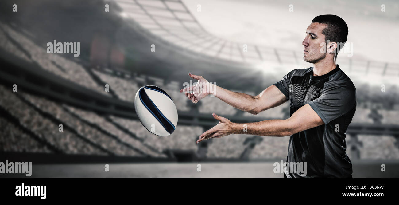 Composite image of rugby player catching ball Stock Photo - Alamy