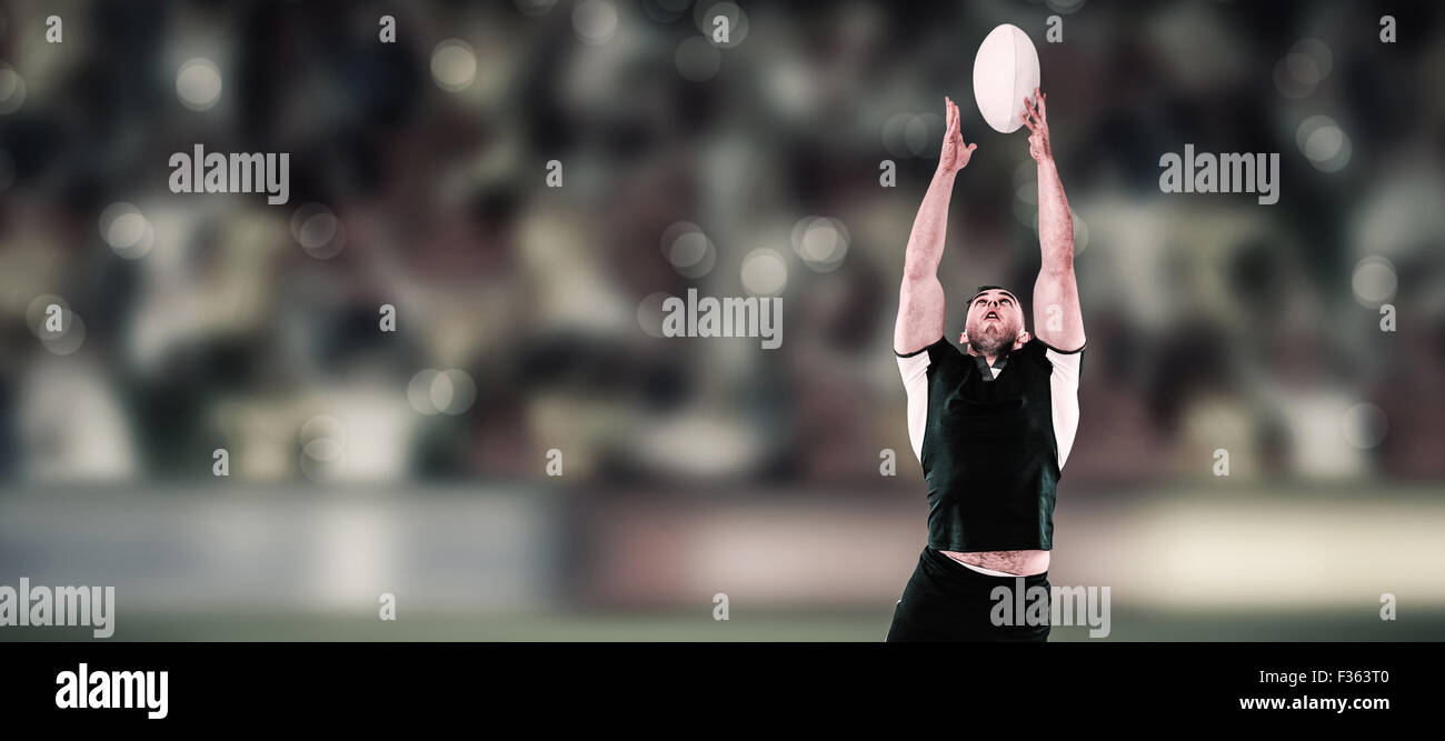 Composite image of rugby player catching the ball Stock Photo - Alamy