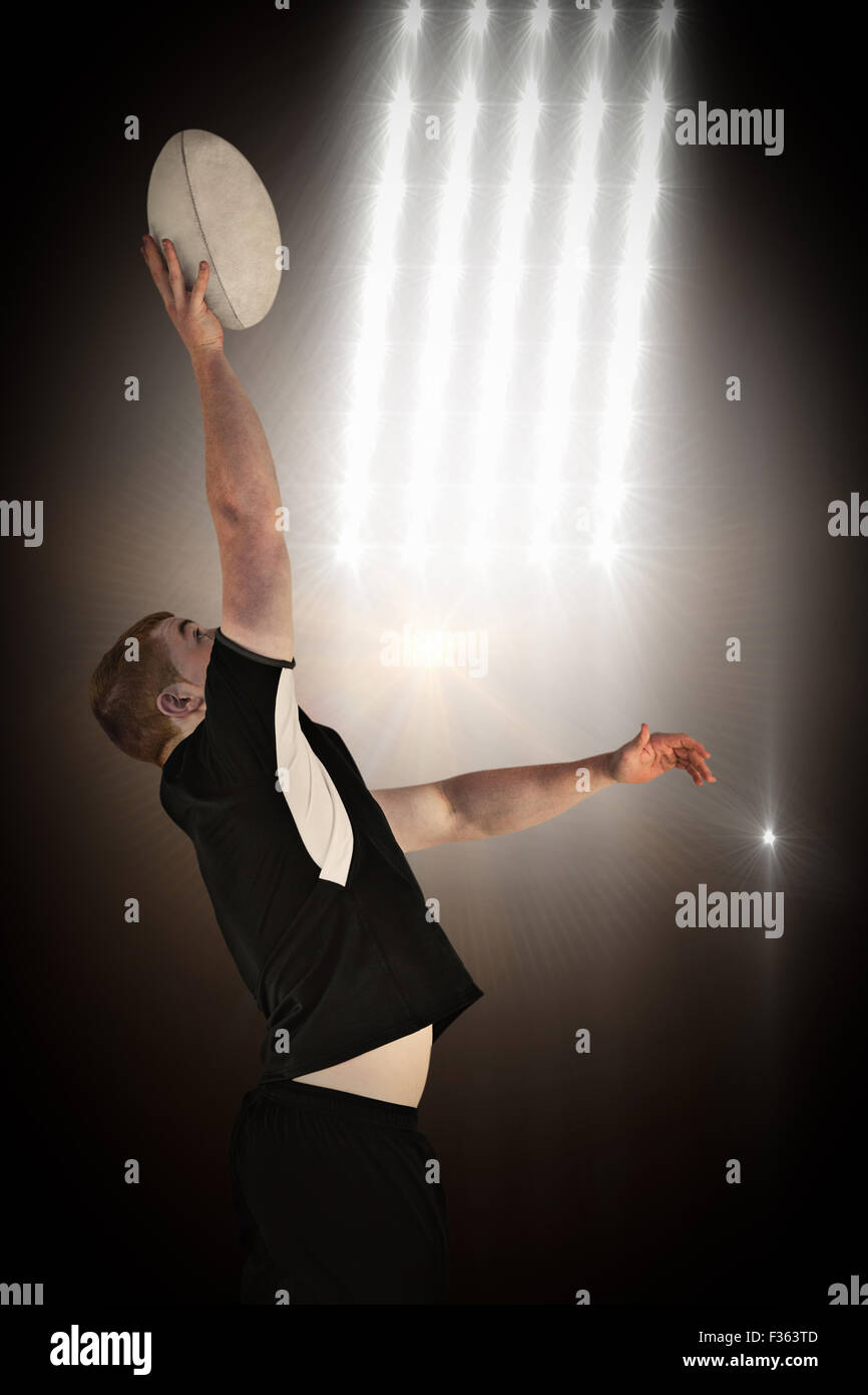 Composite image of rugby player catching a rugby ball Stock Photo - Alamy