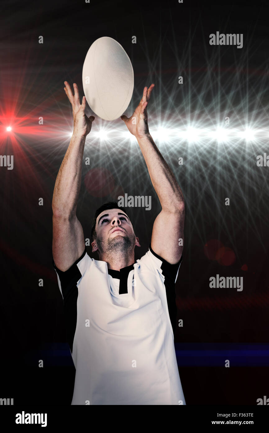 Composite image of rugby player catching the ball Stock Photo - Alamy