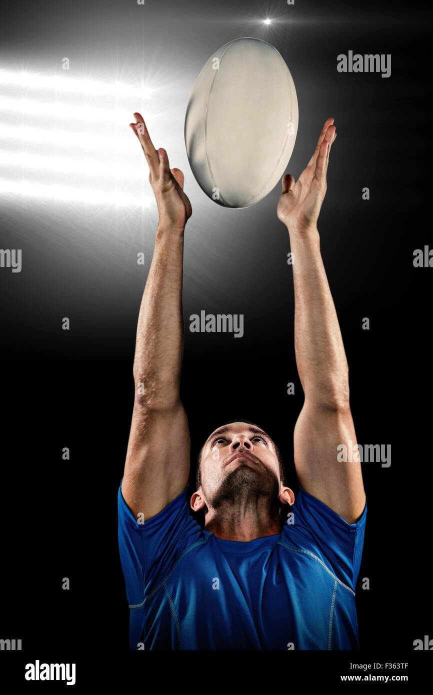 Composite image of rugby player catching ball Stock Photo - Alamy