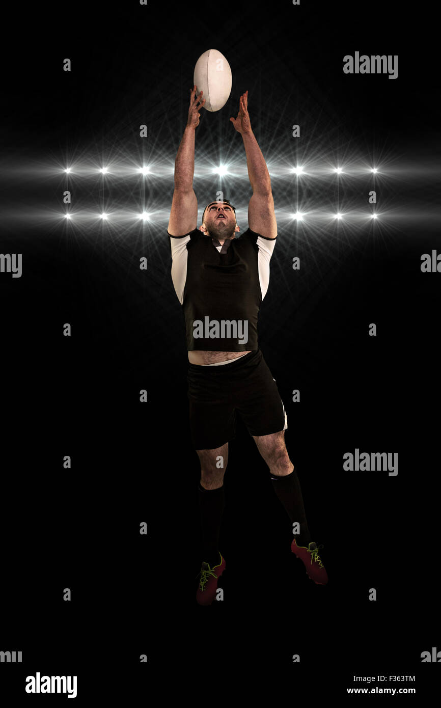 Composite image of rugby player catching the ball Stock Photo - Alamy