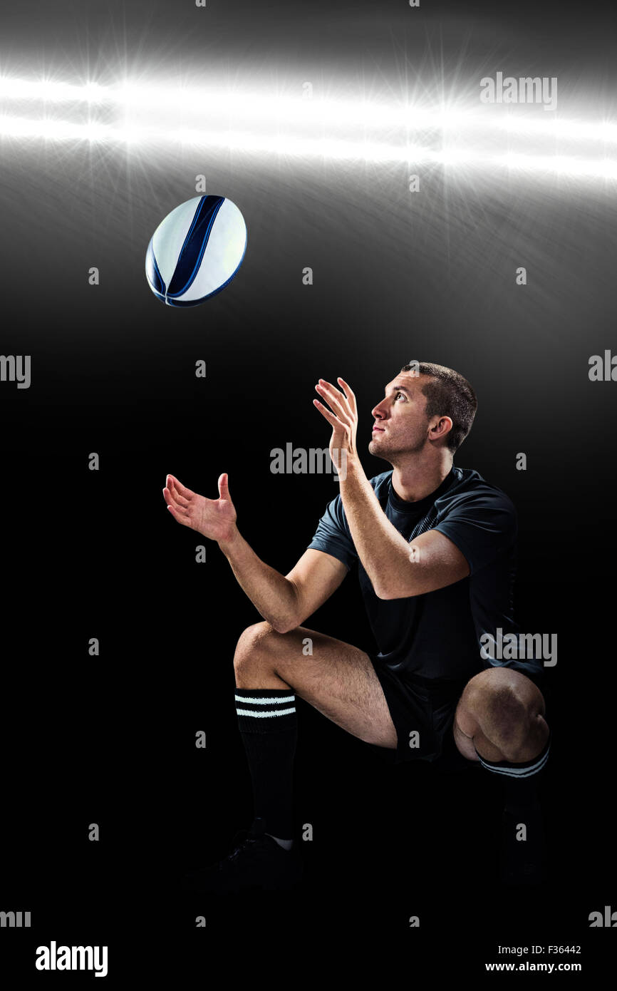 Composite image of full length of rugby player catching the ball Stock ...
