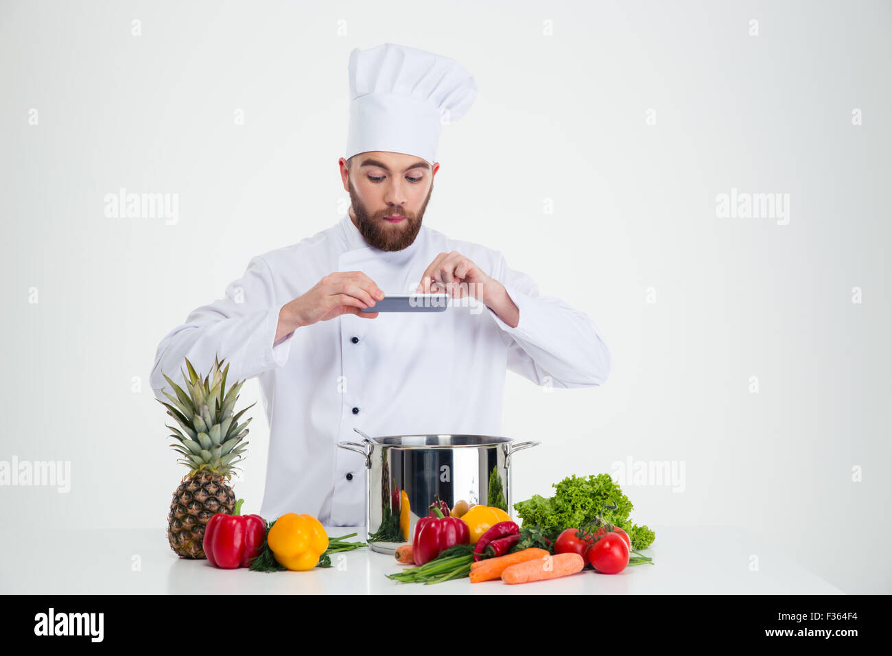 Portrait of a handsome male chef cook making photo of food isolated on ...