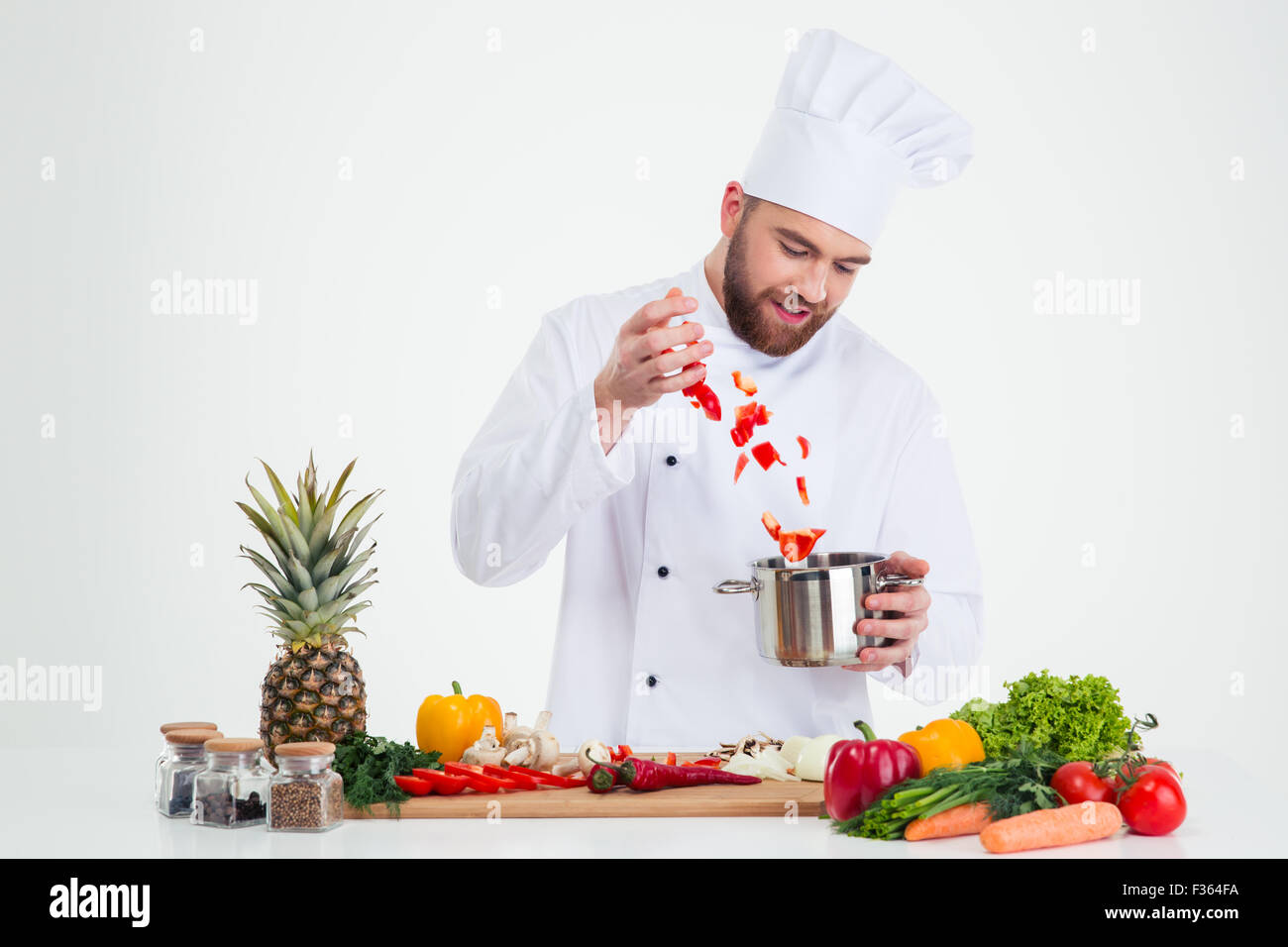 Portrait of a male chef cook preparing soup isolated on a white ...