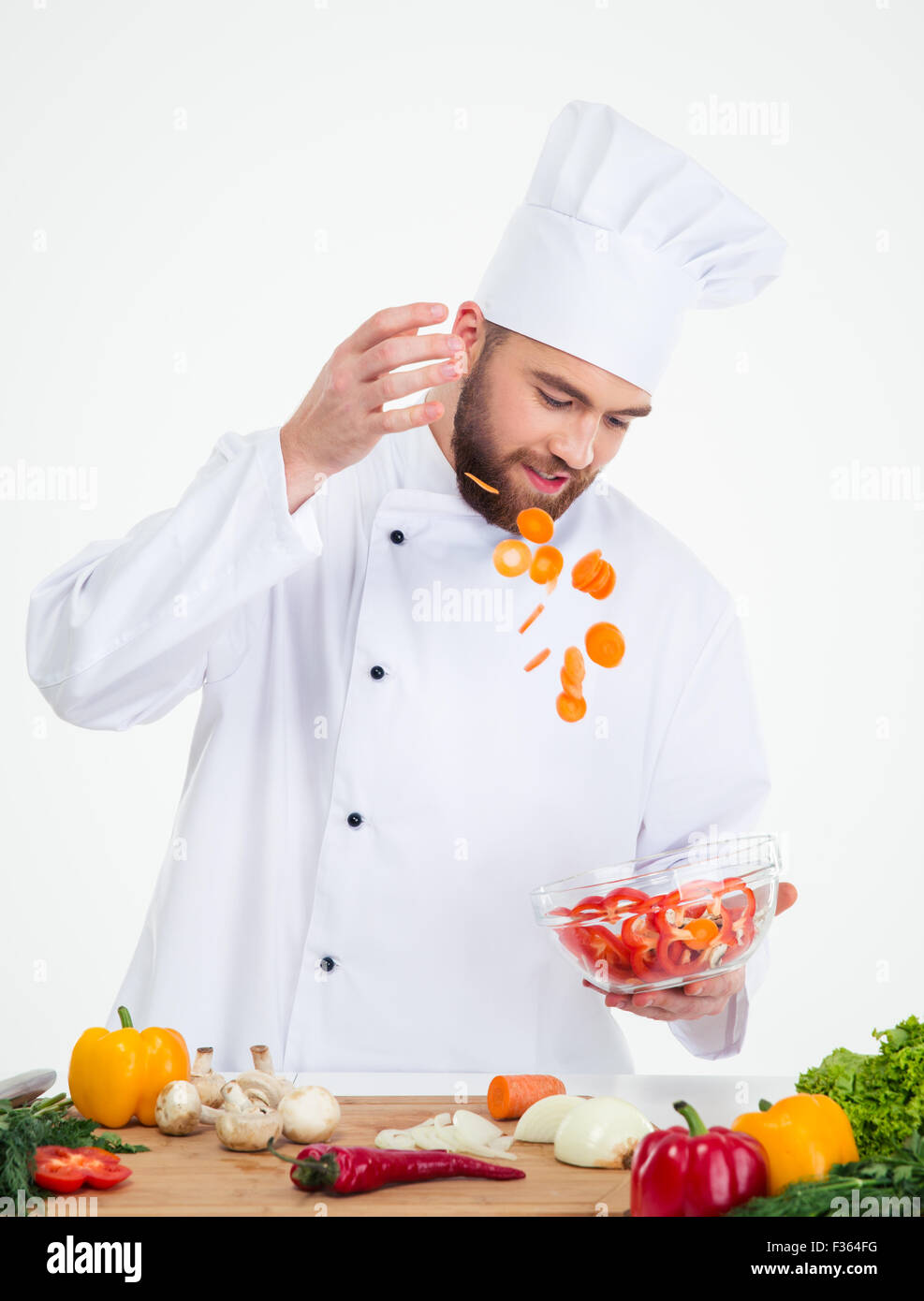 Portrait of a male chef cook preparing salad isolated on a white ...