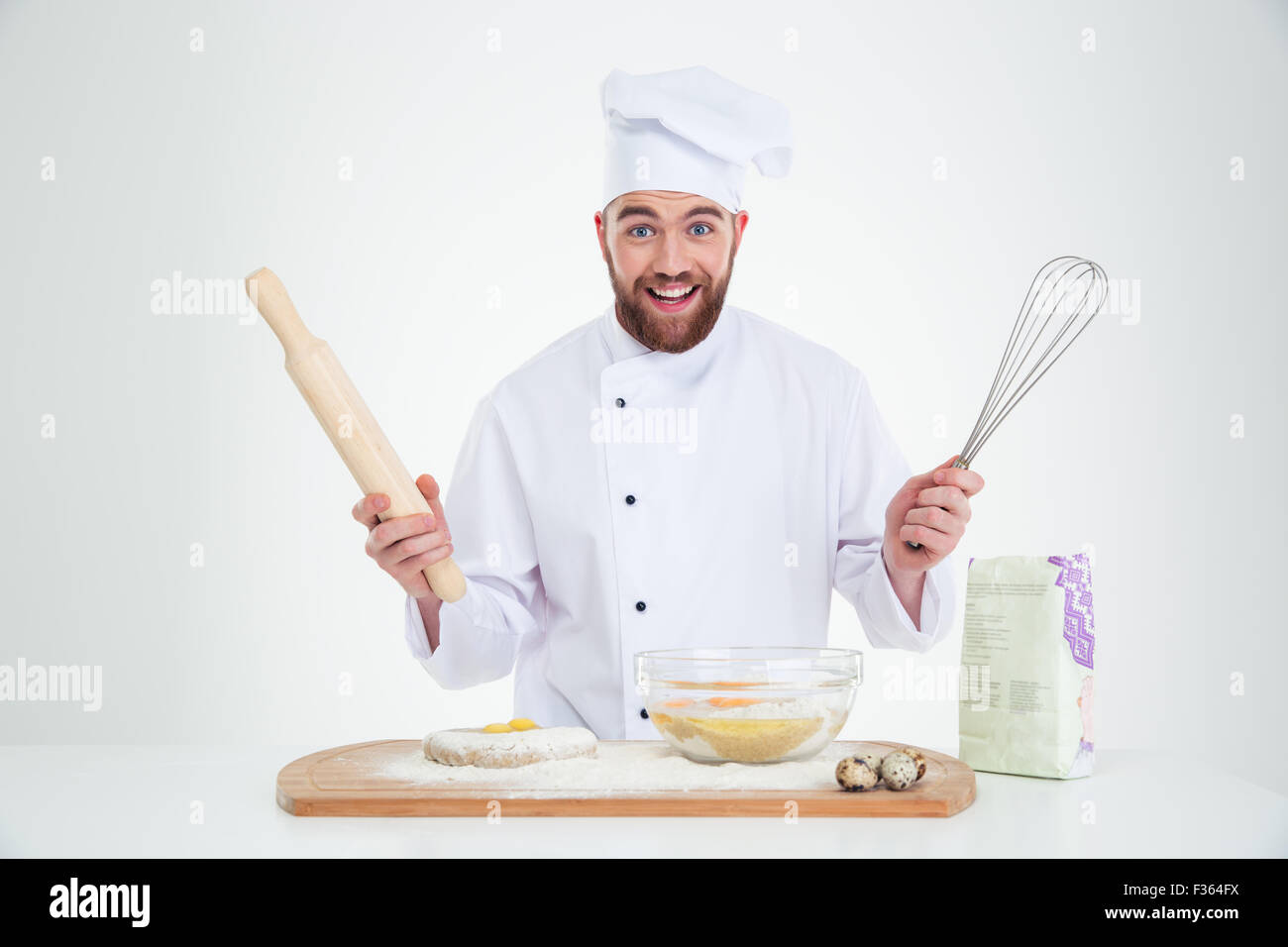Portrait of a cheerful male chef cook baking isolated on a white ...