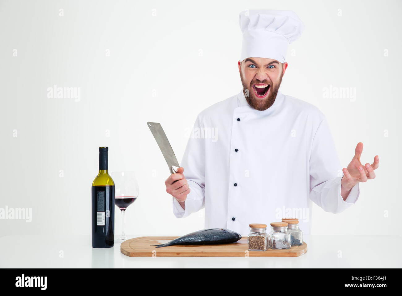 Portrait of a cheerful male chef cook preparing fish isolated on a ...