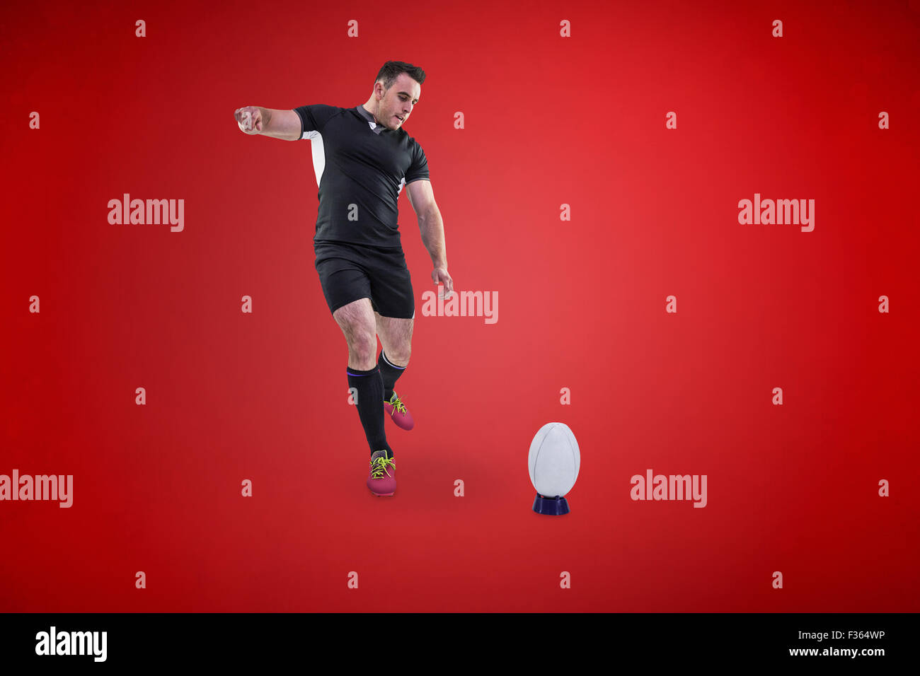 Composite image of rugby player kicking the ball Stock Photo - Alamy