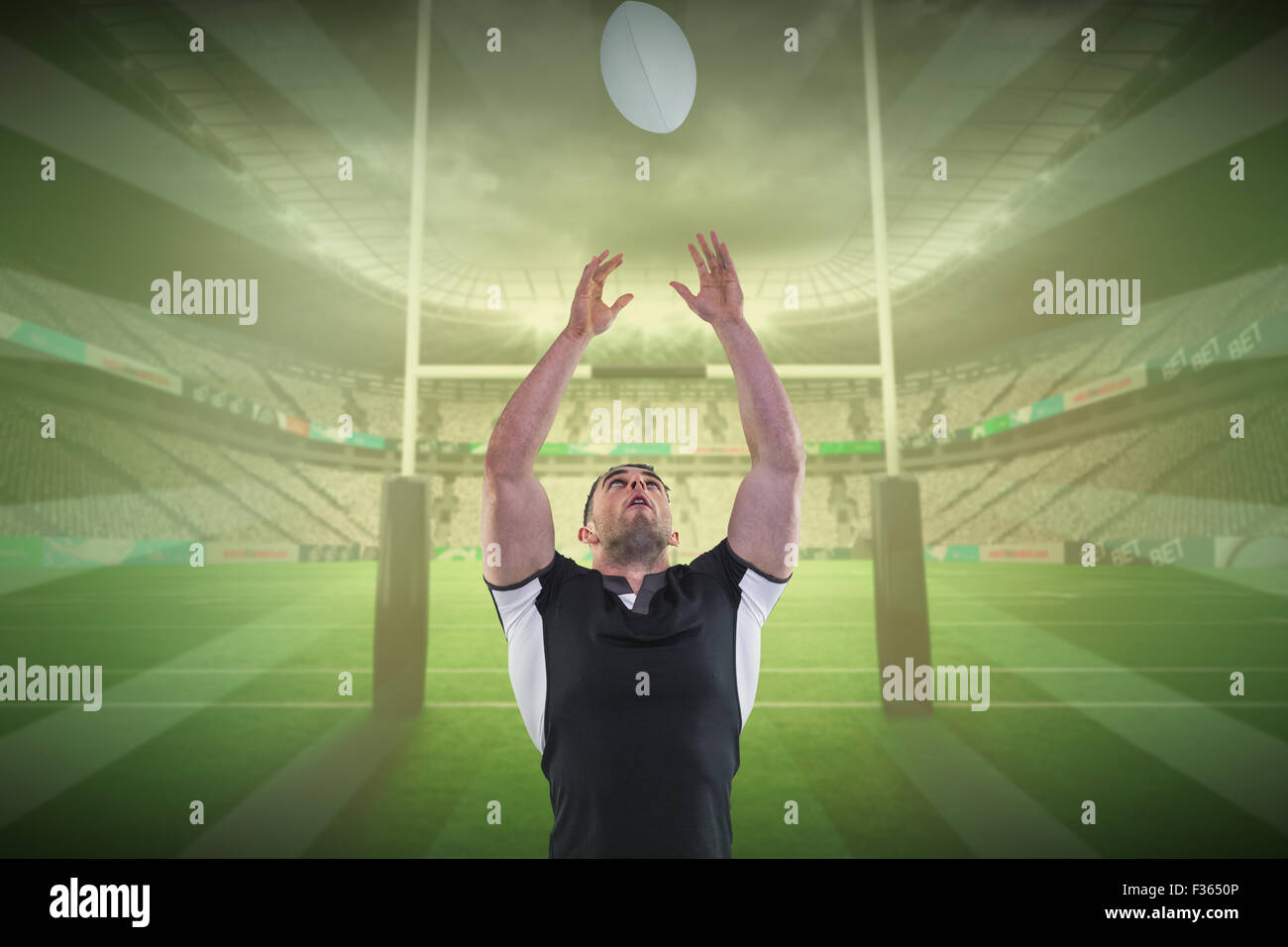 Composite image of rugby player catching the ball Stock Photo - Alamy