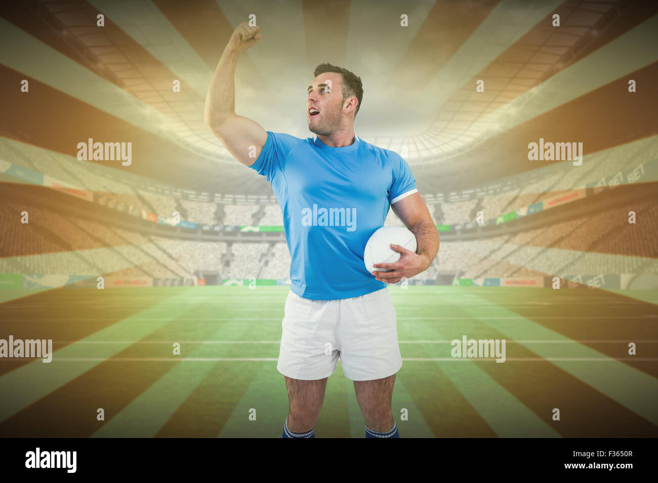 Composite image of rugby player cheering with the ball Stock Photo - Alamy