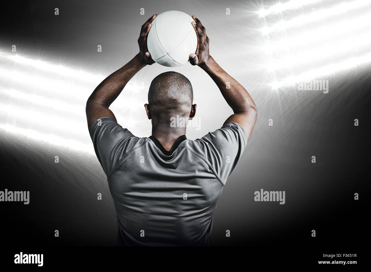Composite image of rear view of athlete throwing rugby ball Stock Photo ...