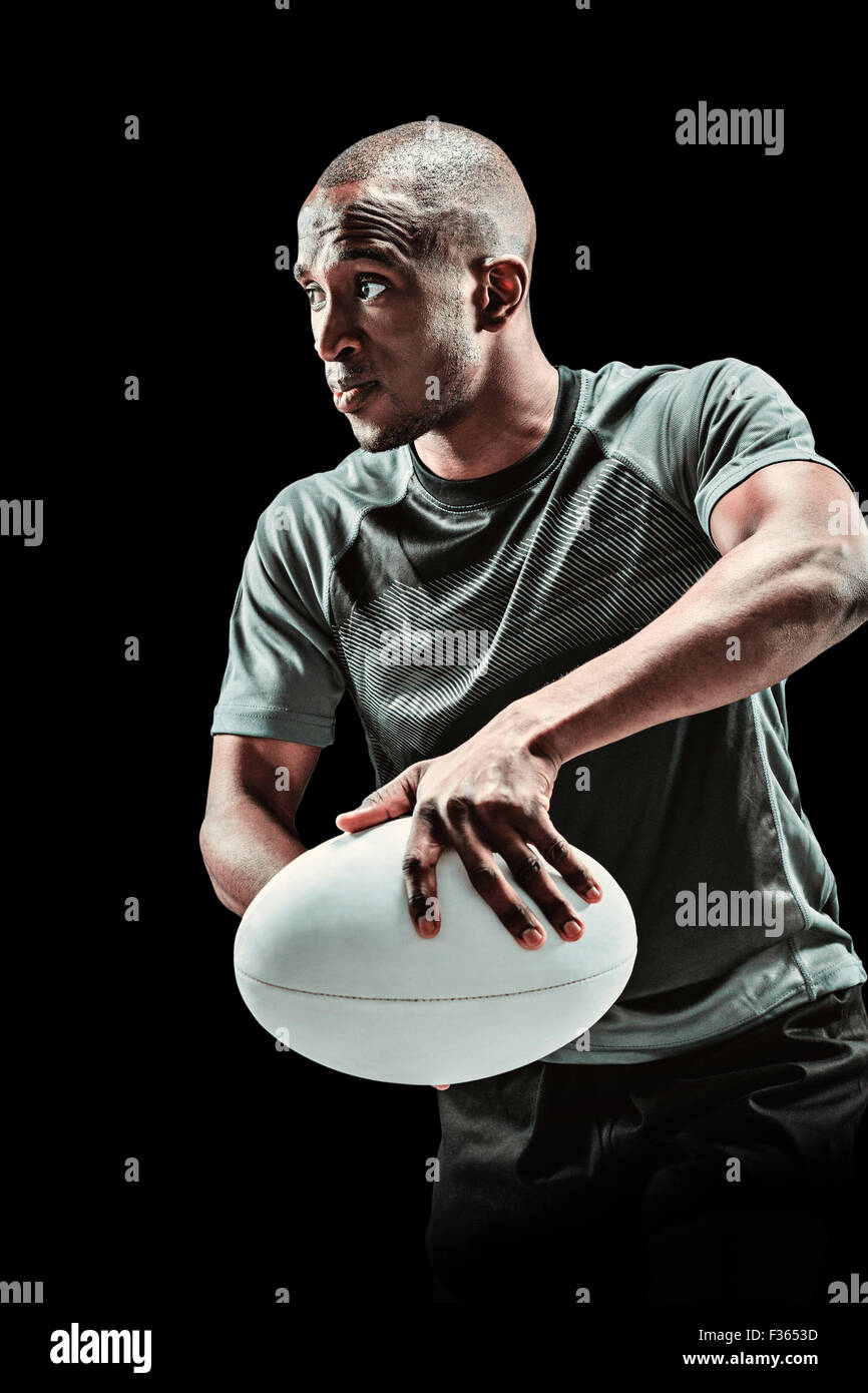 Composite image of determined rugby player in position to throw ball ...