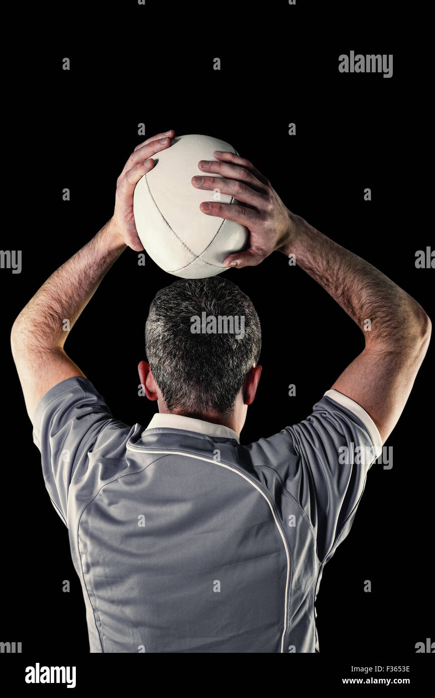 Composite image of rugby player about to throw a rugby ball Stock Photo ...