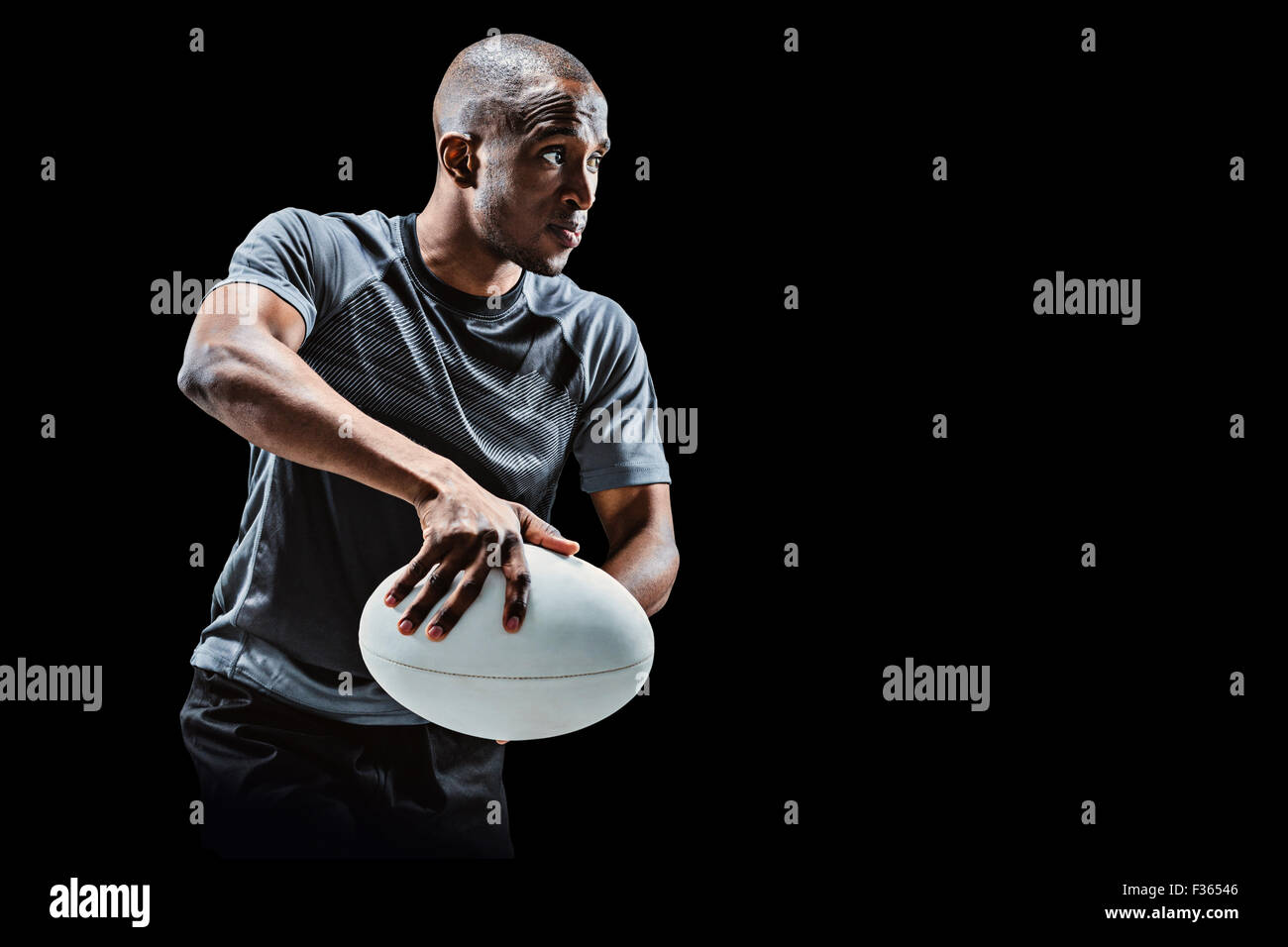 Composite image of determined rugby player in position to throw ball ...