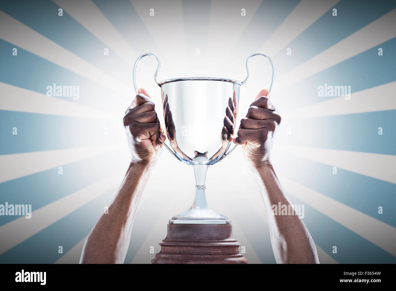 Composite image of cropped hand of athlete holding trophy Stock Photo ...
