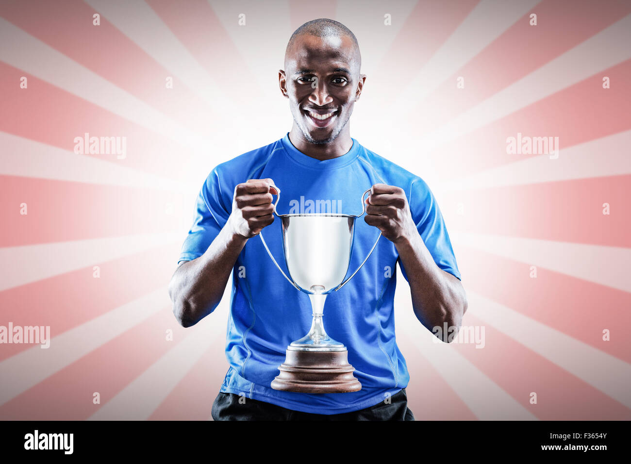 Composite image of portrait of happy sportsman holding trophy Stock ...