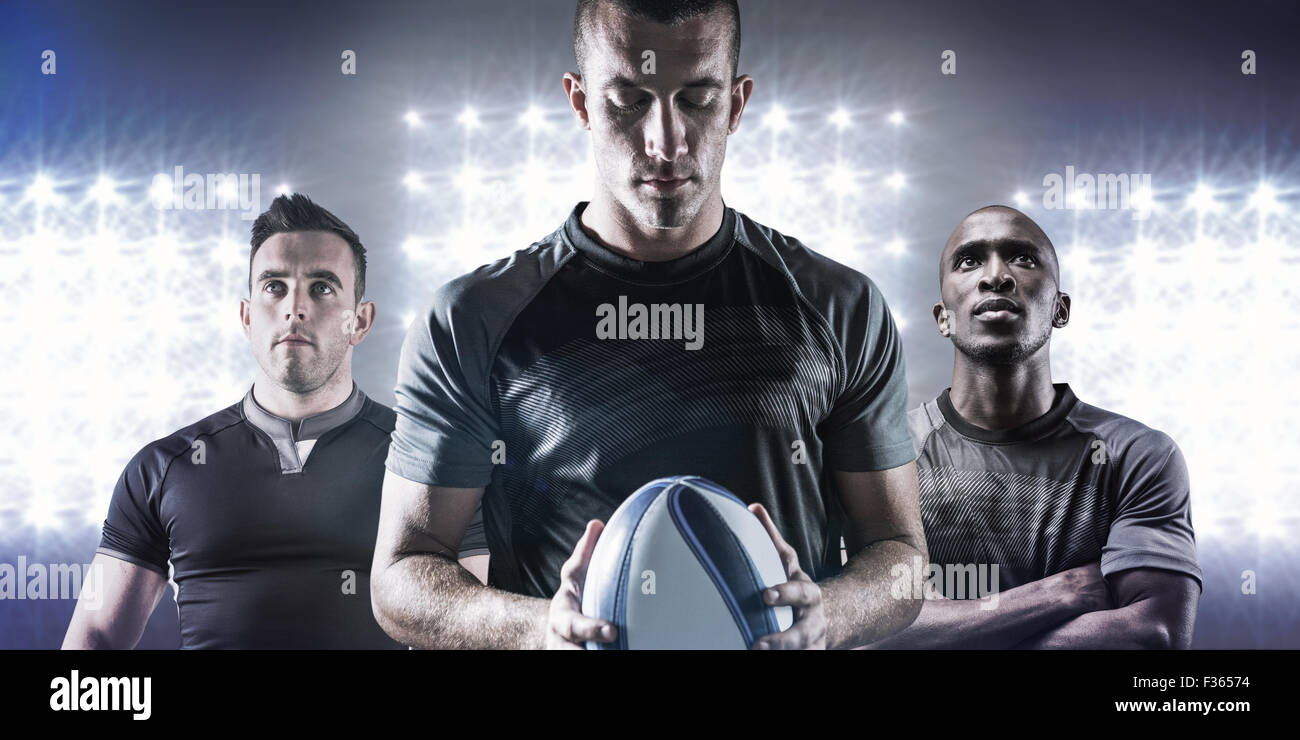 Composite image of thoughtful rugby player holding ball Stock Photo - Alamy