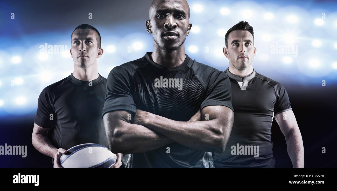 Composite image of portrait of confident rugby player with arms crossed ...