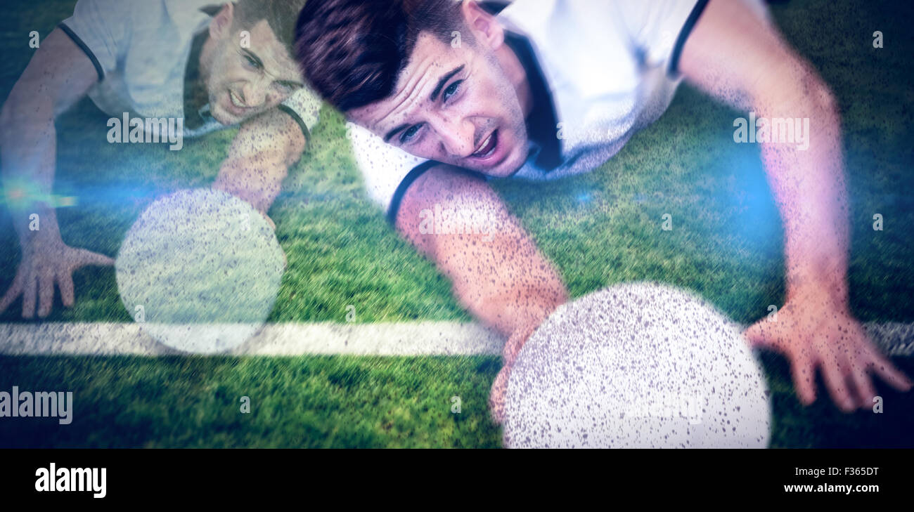 Composite image of man holding rugby ball while lying down Stock Photo ...