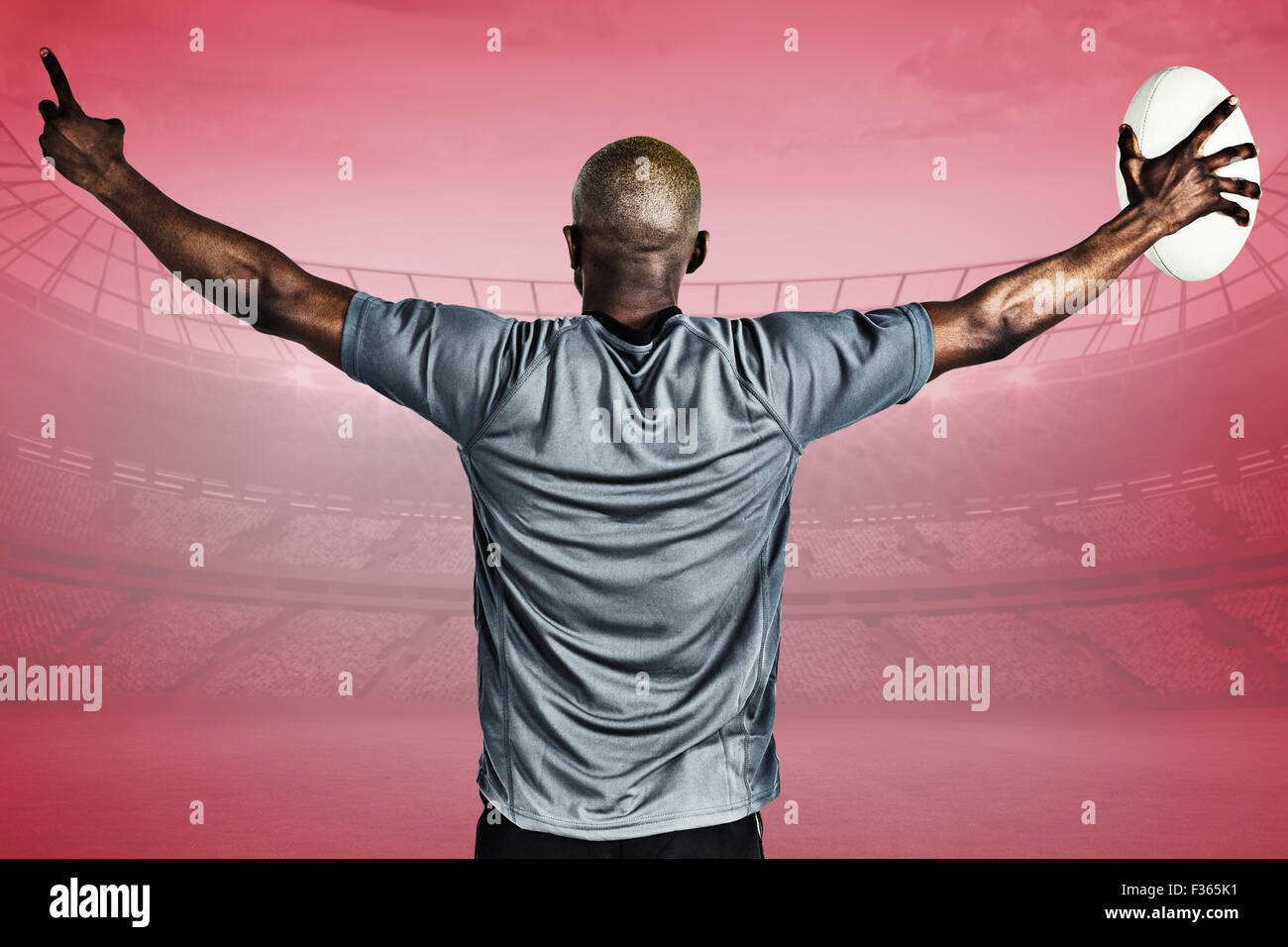 Composite image of rear view of sportsman with arms raised holding ...