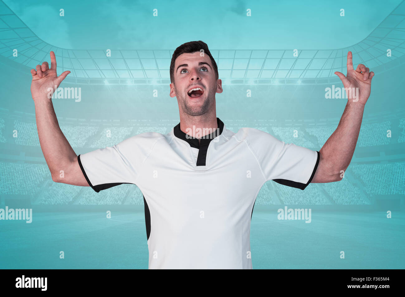 Composite image of surprised rugby player pointing up Stock Photo - Alamy