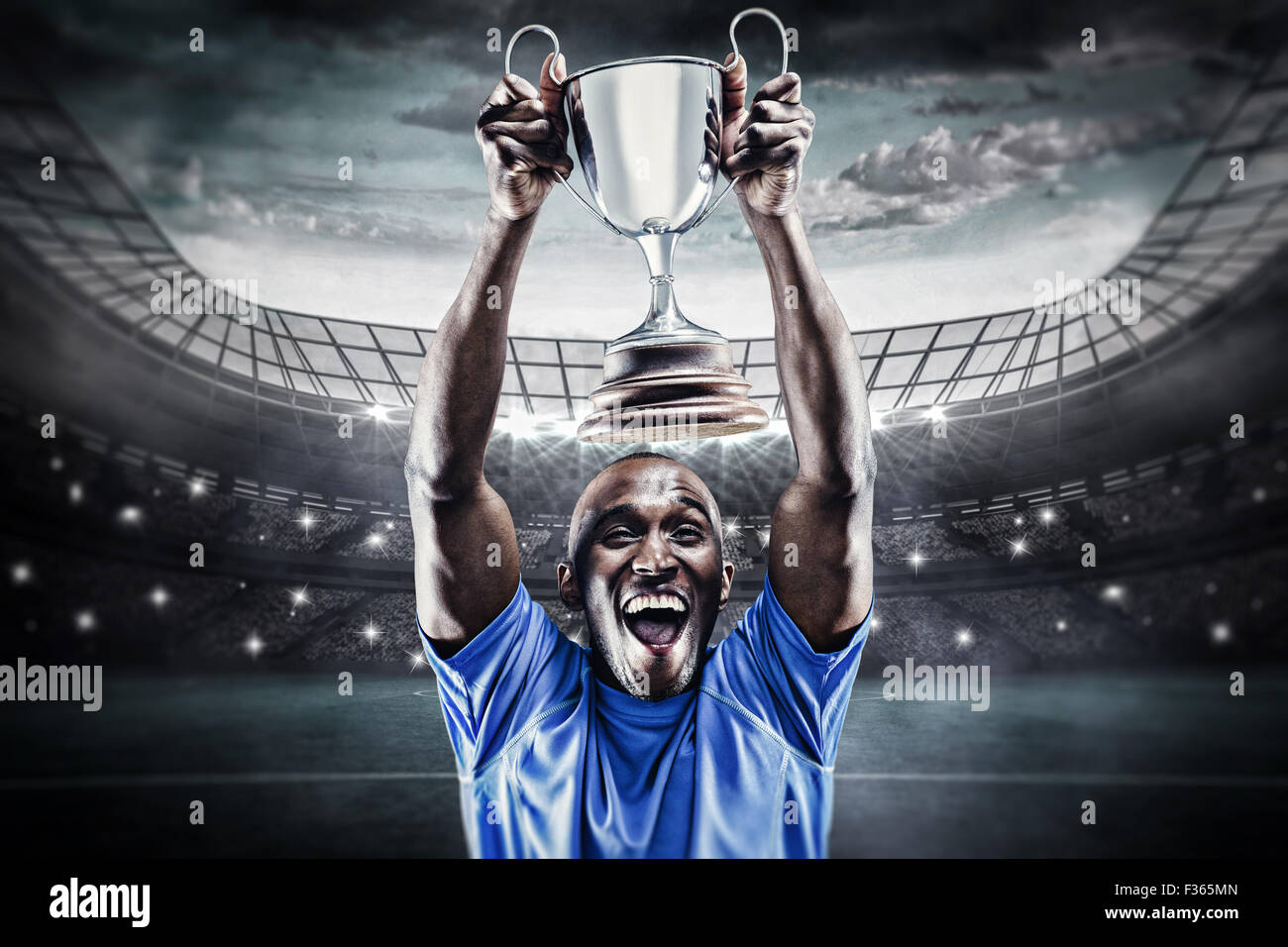 Composite image of happy athlete cheering while holding trophy Stock ...